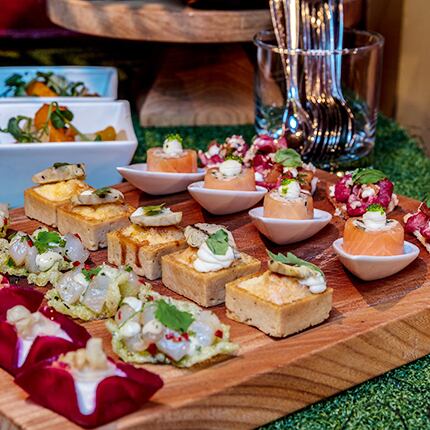 Food on a wooden board in a Cirque du Soleil VIP box